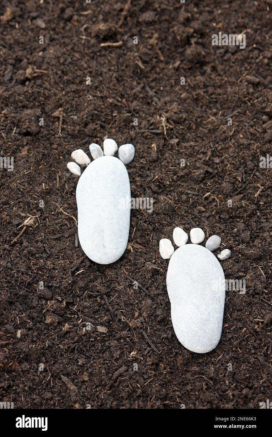 stone feet on the ground Stock Photo - Alamy