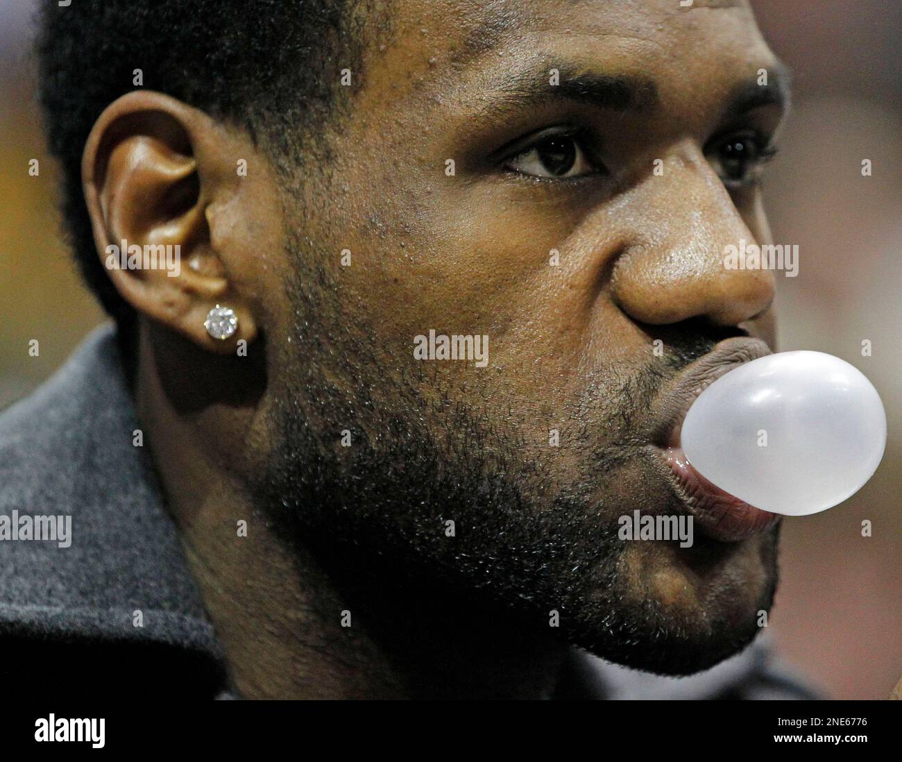 Cleveland Cavaliers' LeBron James blows a bubble while on the bench in ...