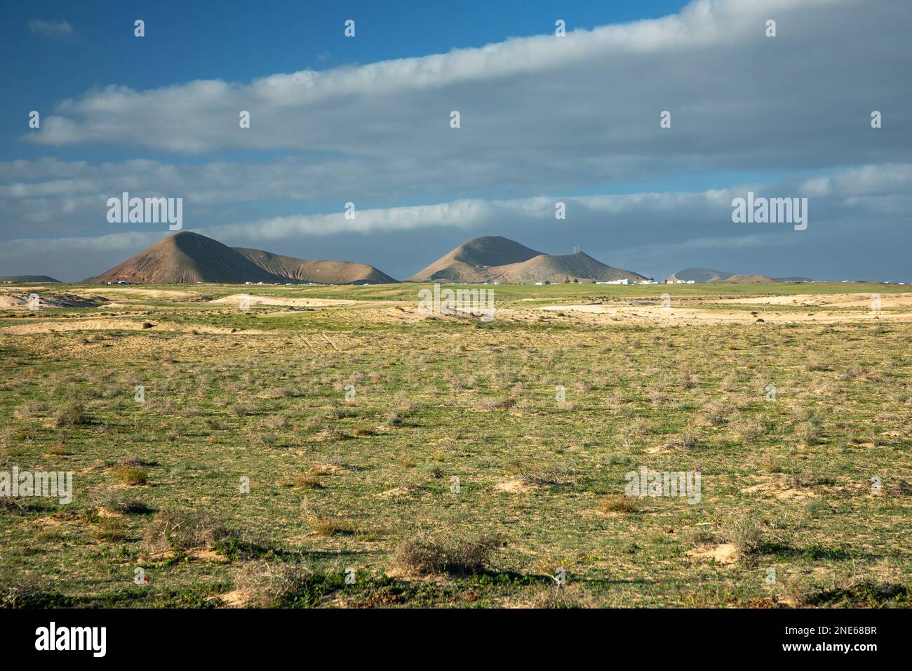 El Jable sand plain with volcanic mountains like Montana Tamia in the ...
