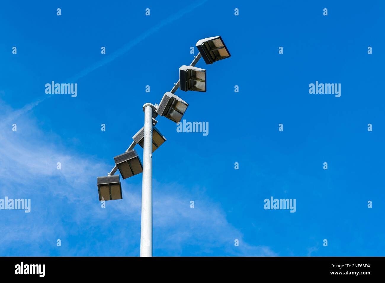 A pillar with spotlights above the stadium against the blue sky Stock ...