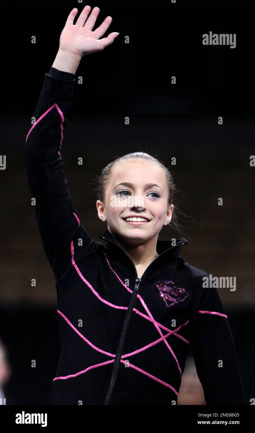 Lexie Priessman of the Cincinnati Gymnastics Academy in Ohio waves ...