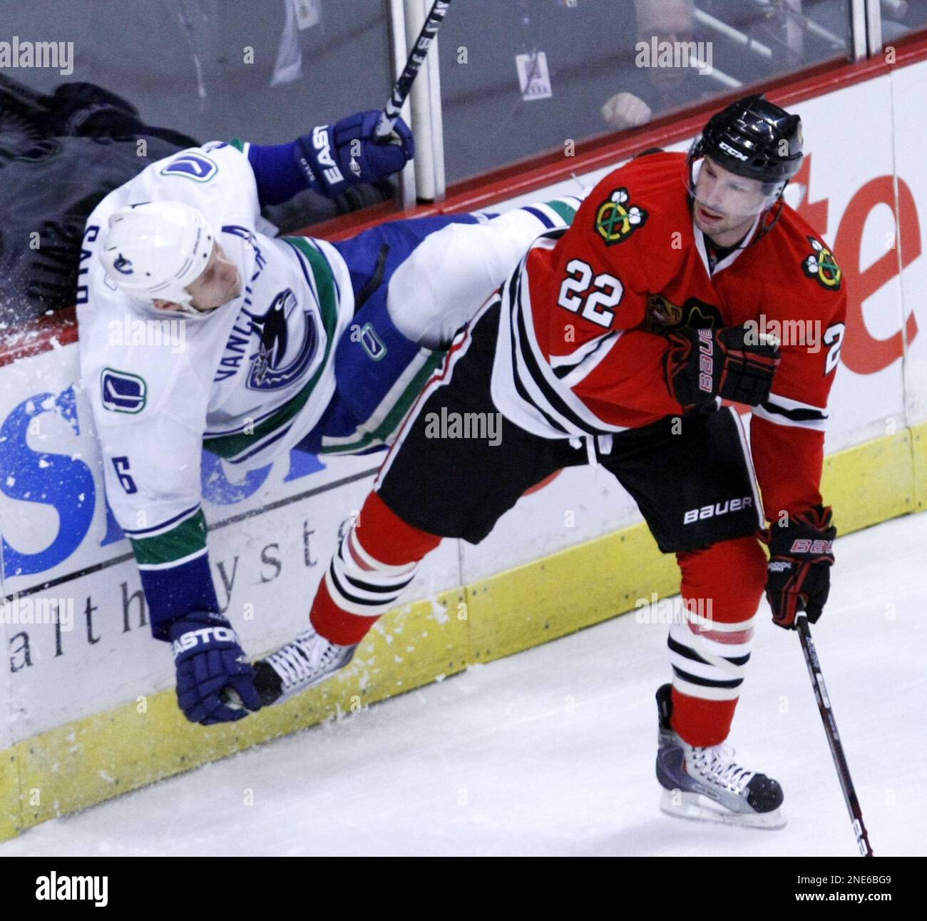 Chicago Blackhawks right wing Troy Brouwer, right, checks Vancouver ...