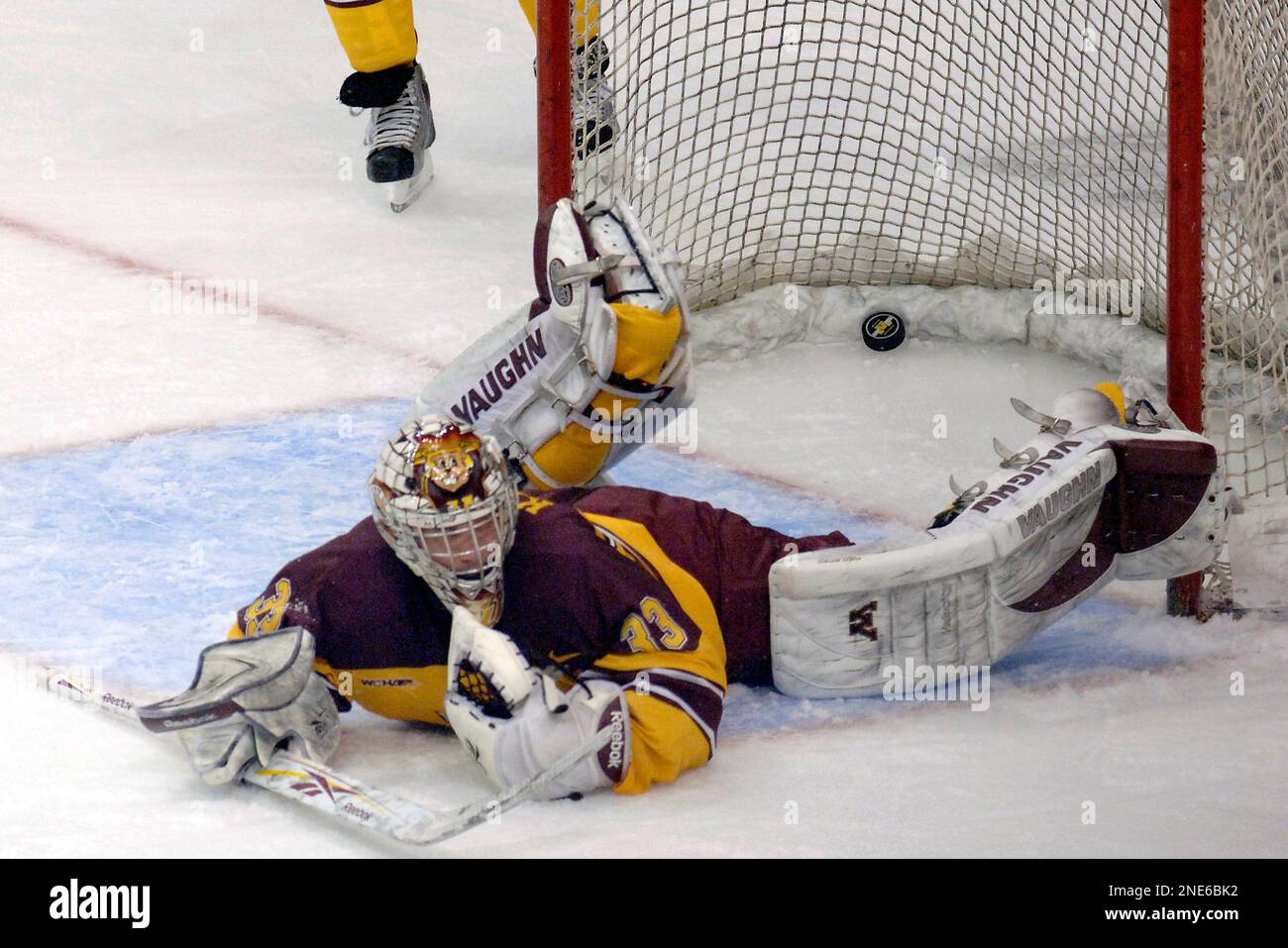 Minnesota goalie Alex Kangas lets a puck through on a shot by Wisconsin ...