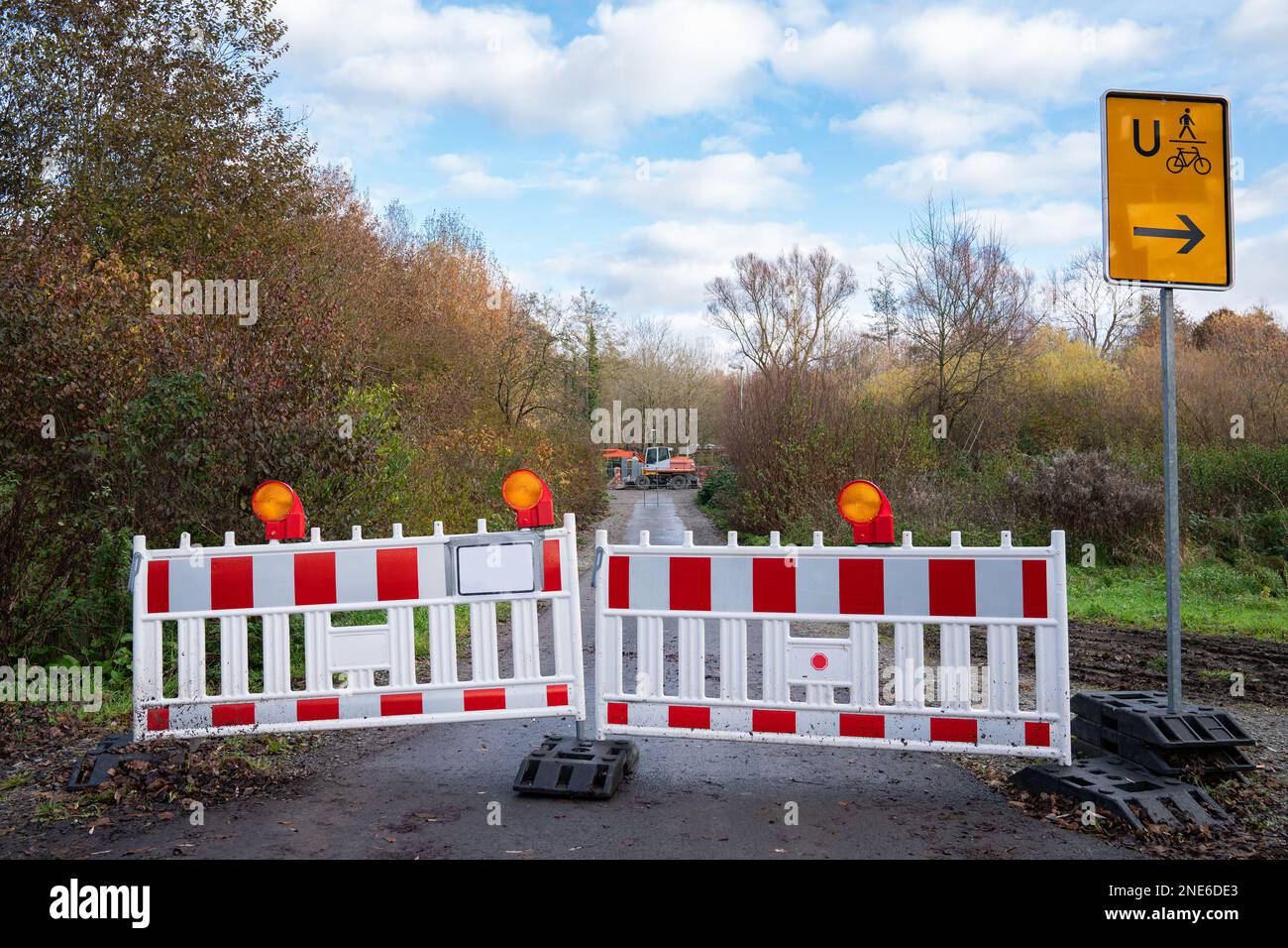 Mobile plastic red and white barriers with orange lights block the ...