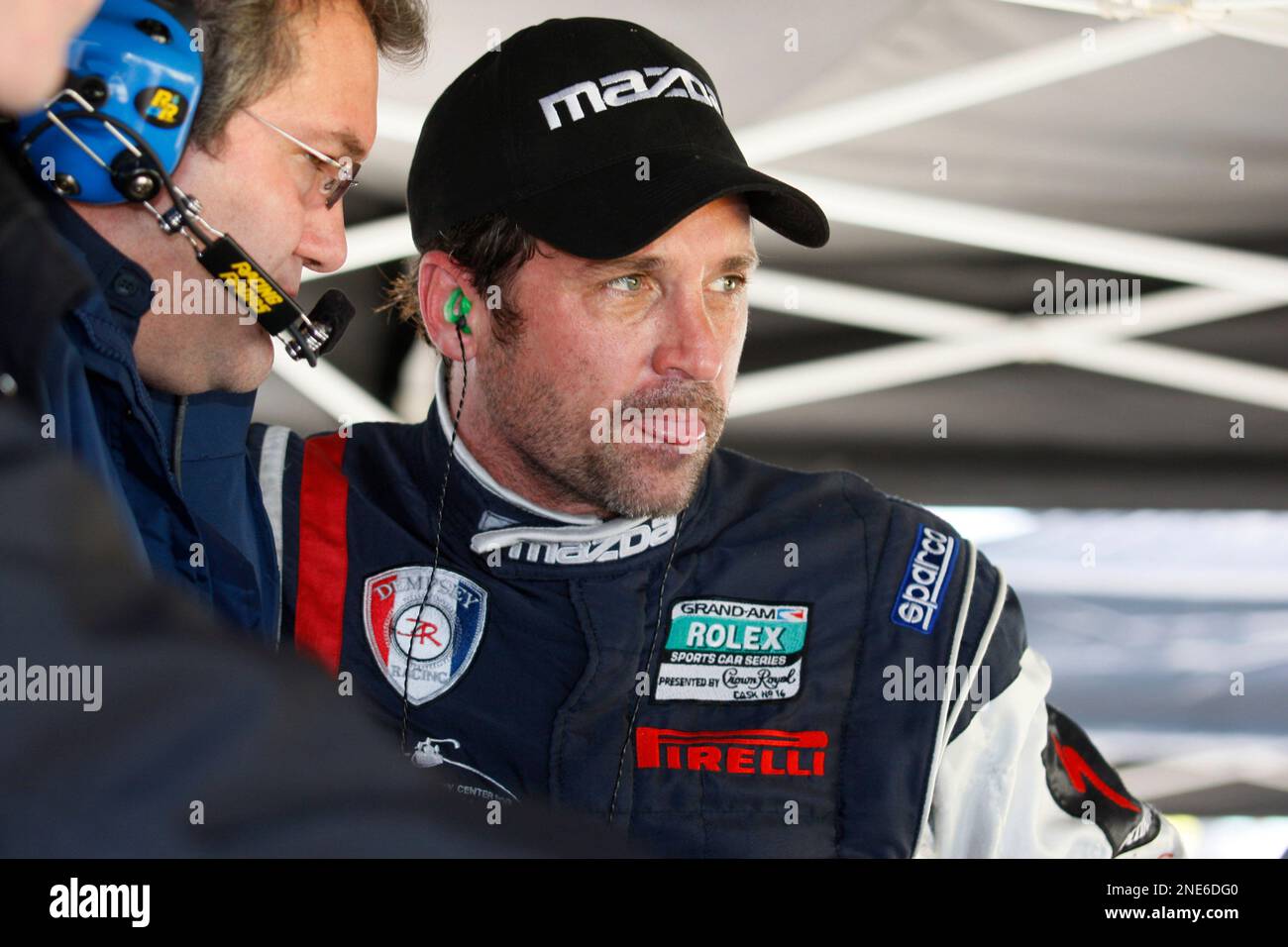 Driver/actor Patrick Dempsey talks to members of his crew during ...