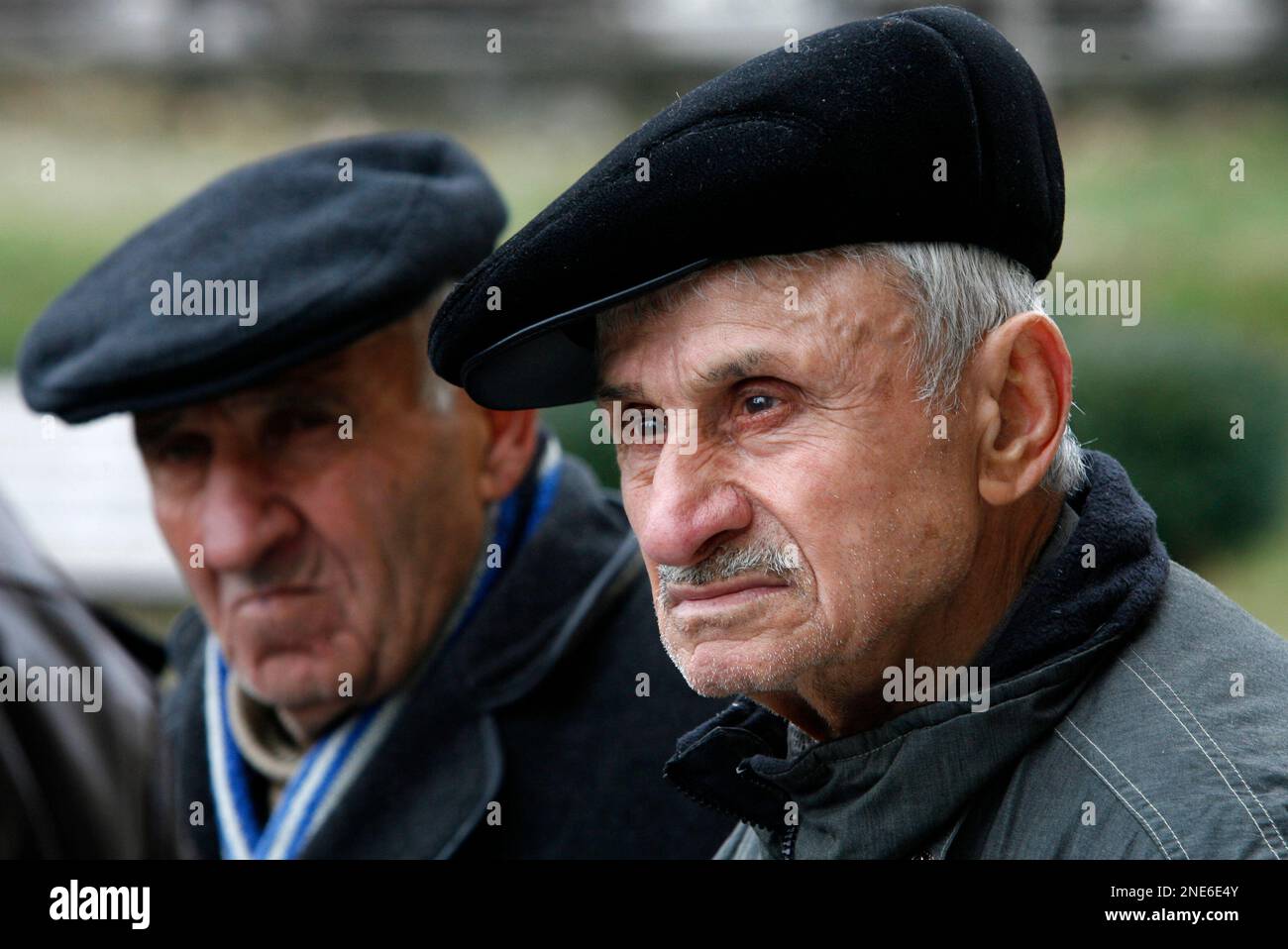 Elderly men wearing big peaked caps, traditional for Georgians, seen ...