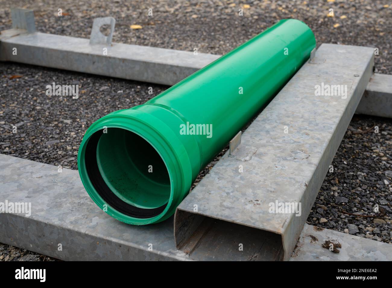 A piece of green plastic pipe with a connecting flange at the end ...