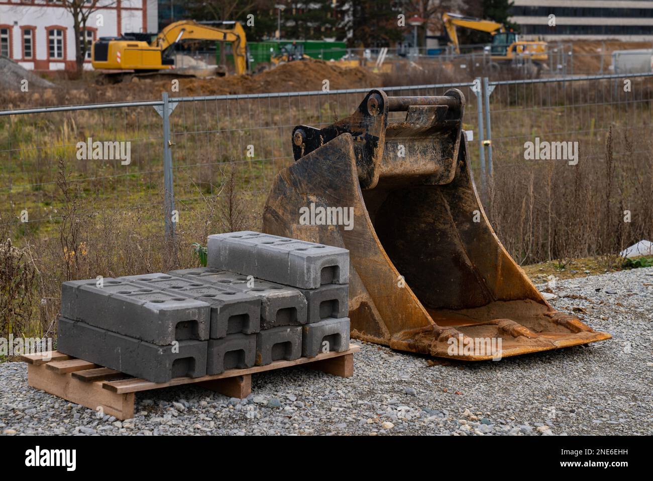 Concrete blocks and bulldozer bucket at construction site. Close-up ...