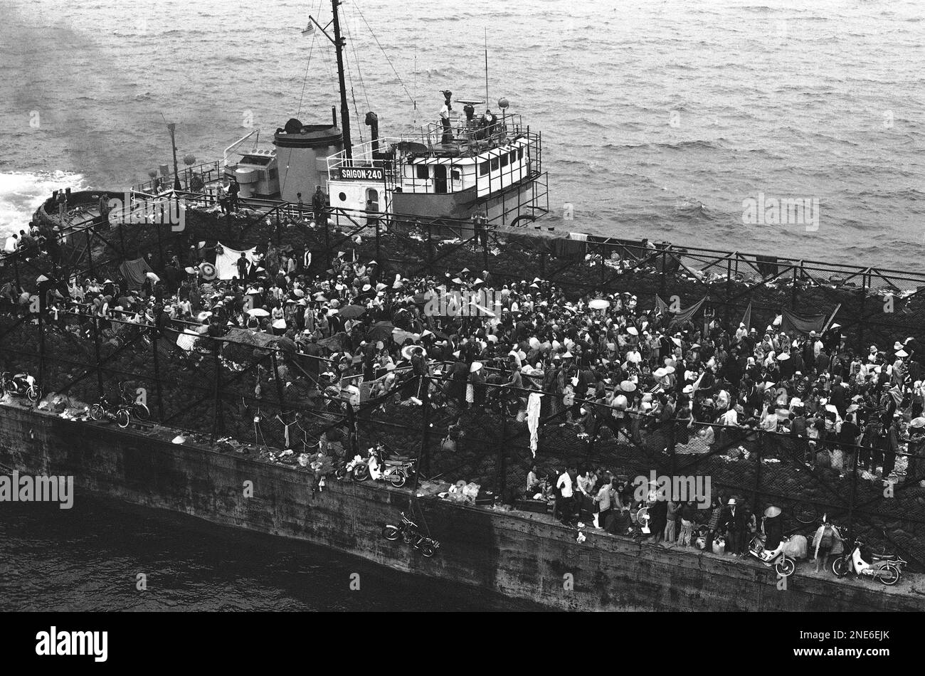 General view of tugboat pushing barge-load of about 3500 panic-stricken ...