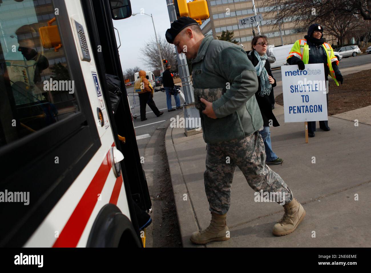 Alease Turner, far right, with Metro, welcomes people to a shuttle bus ...
