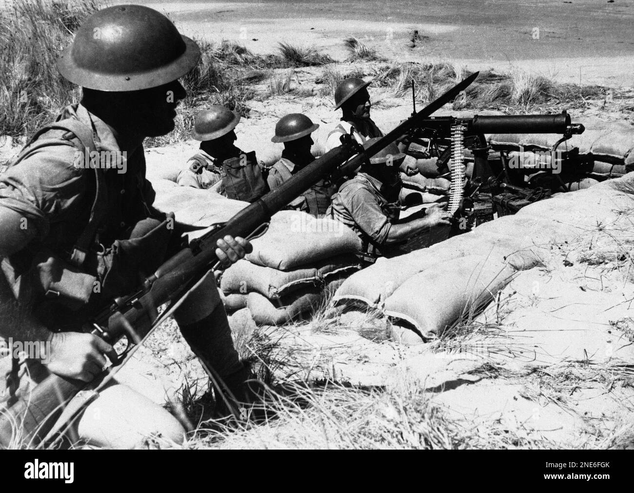 A sand-bagged machine-gun post, with the crew at their stations ...