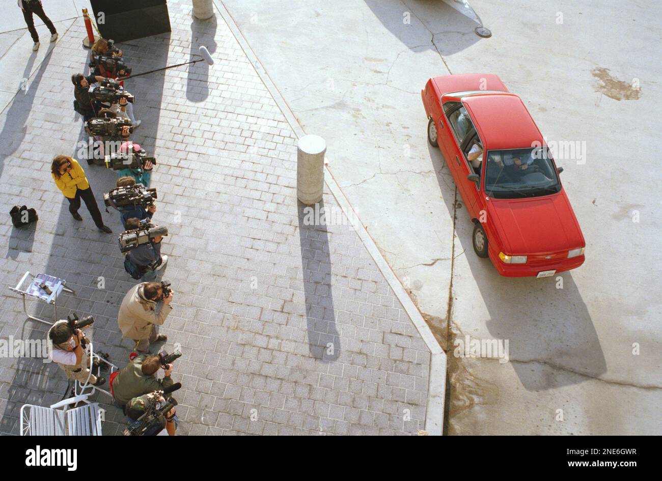 Television and still photographers, held back by police lines ...