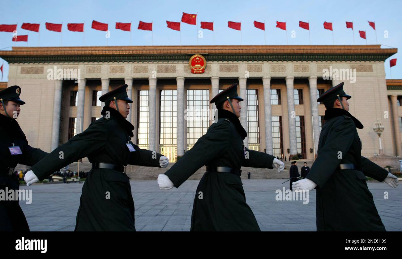 Paramilitary police officers march in front of the Great Hall of the ...