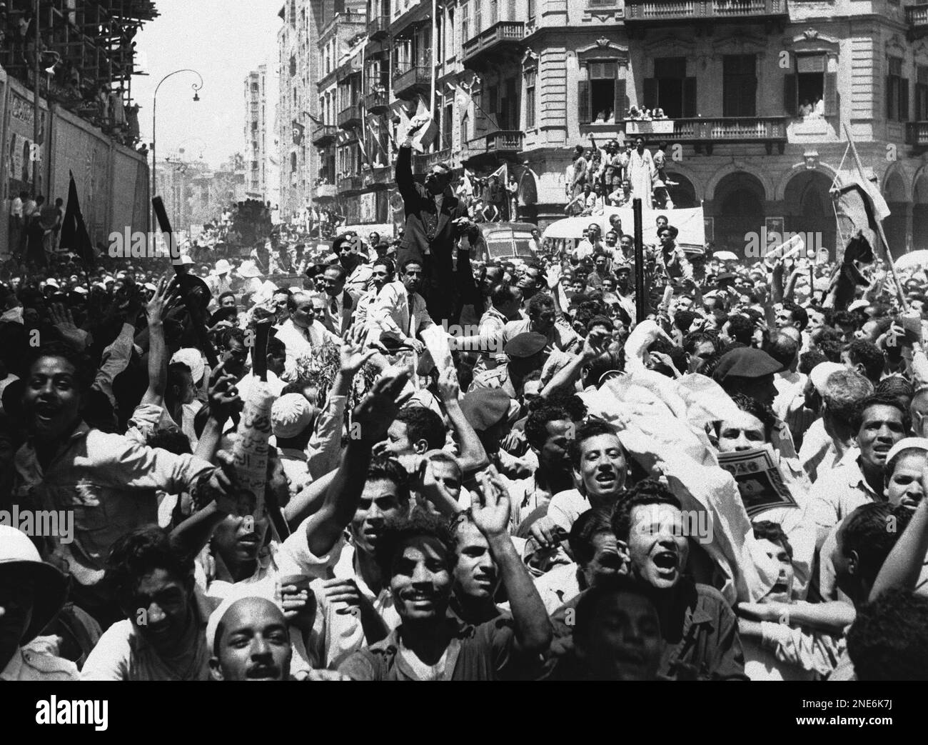 A huge, Wildly cheering crowd surrounds the car of President Gamal ...