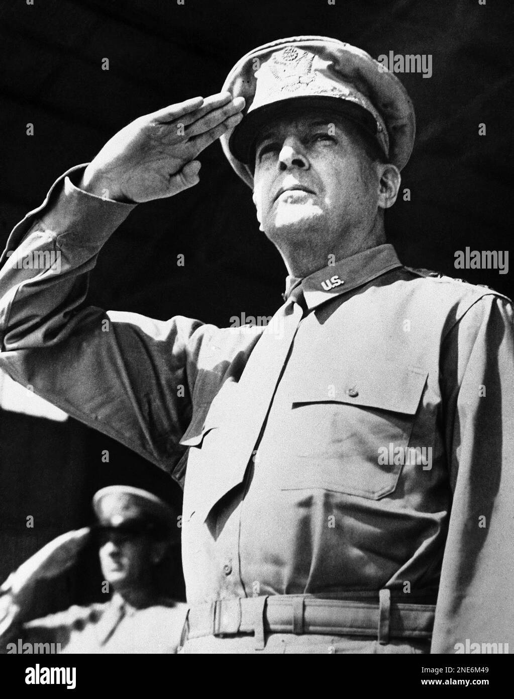 General Douglas Macarthur, saluting during a parade in Philippines ...