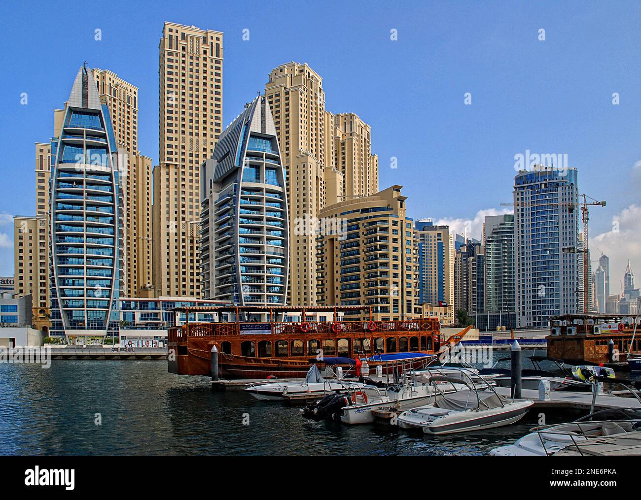 Traditional dhow passing modern boats in Dubai Marina Stock Photo - Alamy