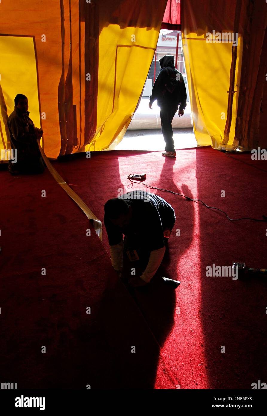 Workers install red carpet outside the Kodak Theatre in the Hollywood ...