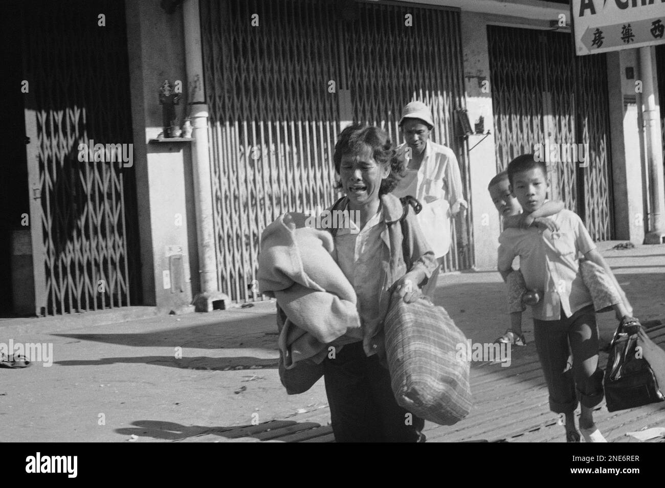 A Vietnamese woman reacts in this fashion as she flees from inside Xuan ...