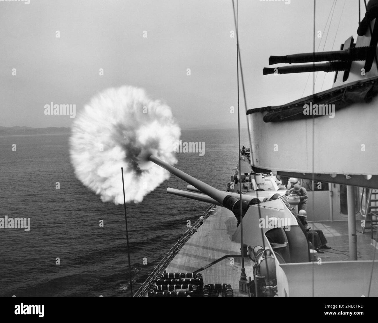The nuzzle blast of the battleship U.S.S. Iowa's 16-inch rifle makes a ...