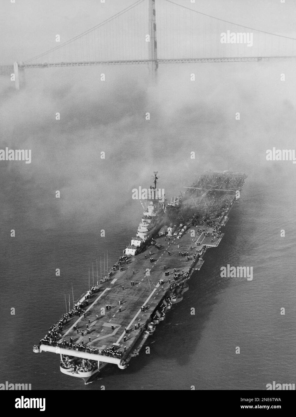The aircraft carrier U.S.S. Boxer creeps through the fog under the ...
