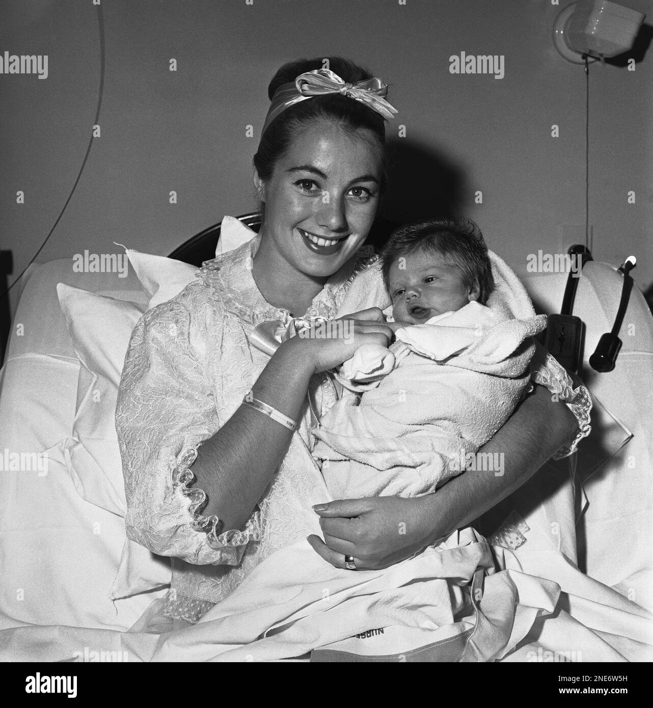Actress Shirley Jones tweaks the chin of her new baby boy as mother and ...