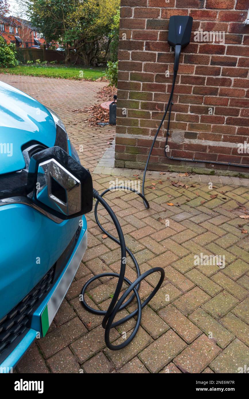 Home EV electric car charging on a 7kw home wall charger Stock Photo ...