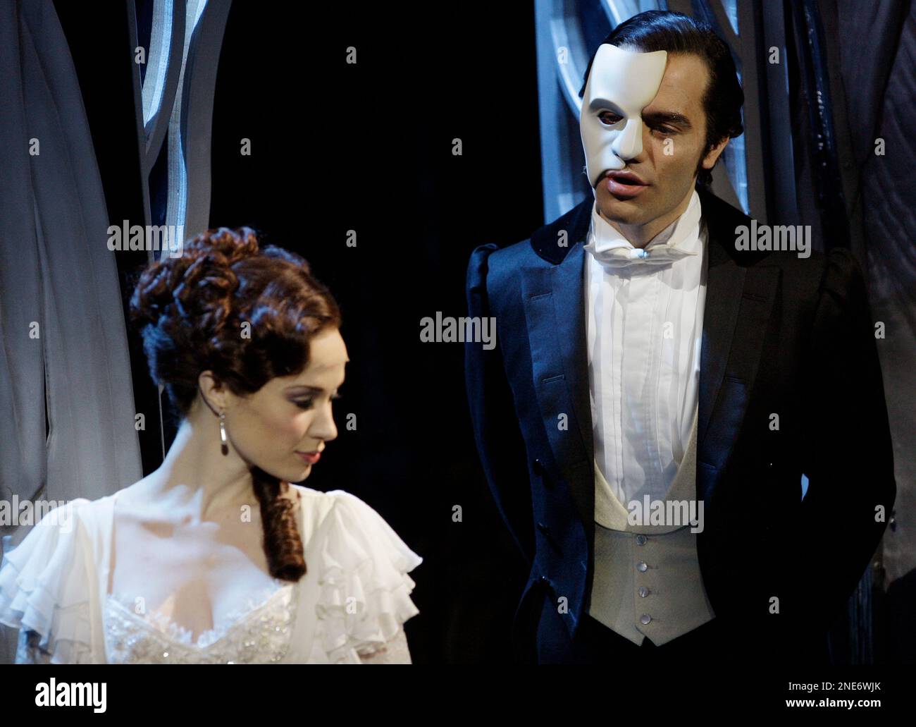 The Phantom, played by Ramin Karimloo, right, performs a scene with ...
