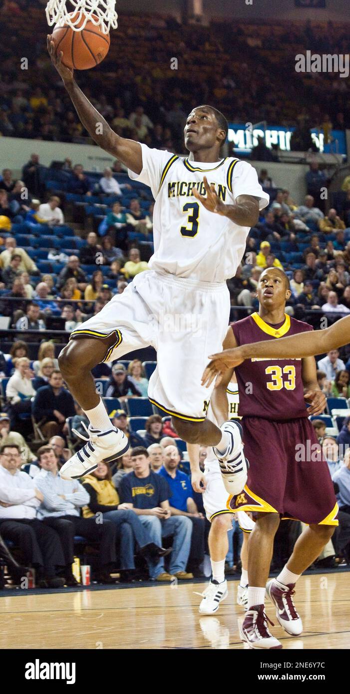 Michigan guard Manny Harris (3) goes for a layup, as Minnesota forward ...