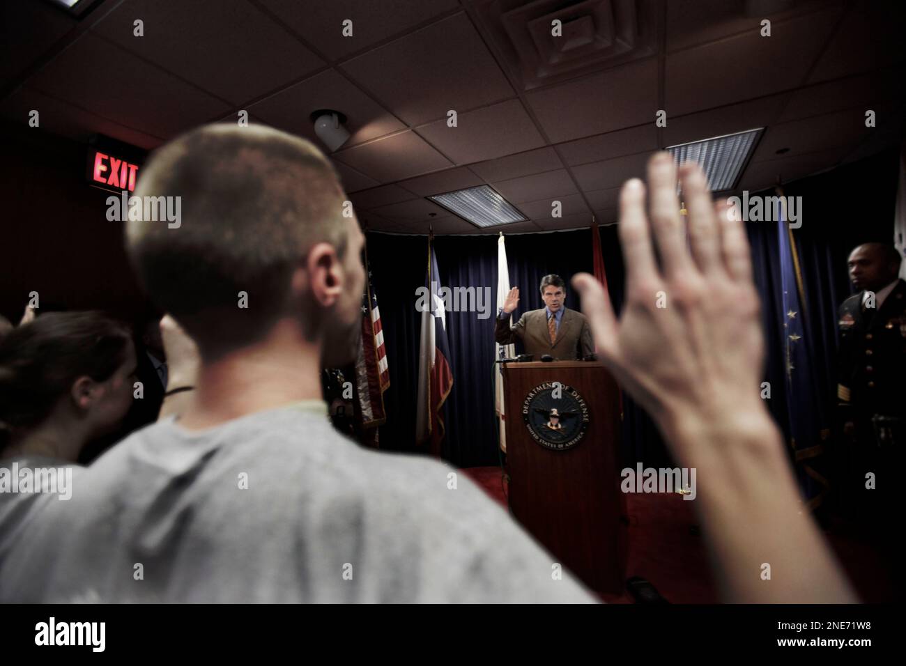 U.S. Army recruit James Michael Sego, left, raises his had as Texas Gov ...