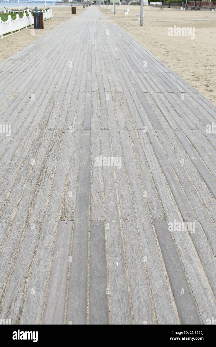 close up, low angle, of boardwalk lining the beach in summertime Stock ...