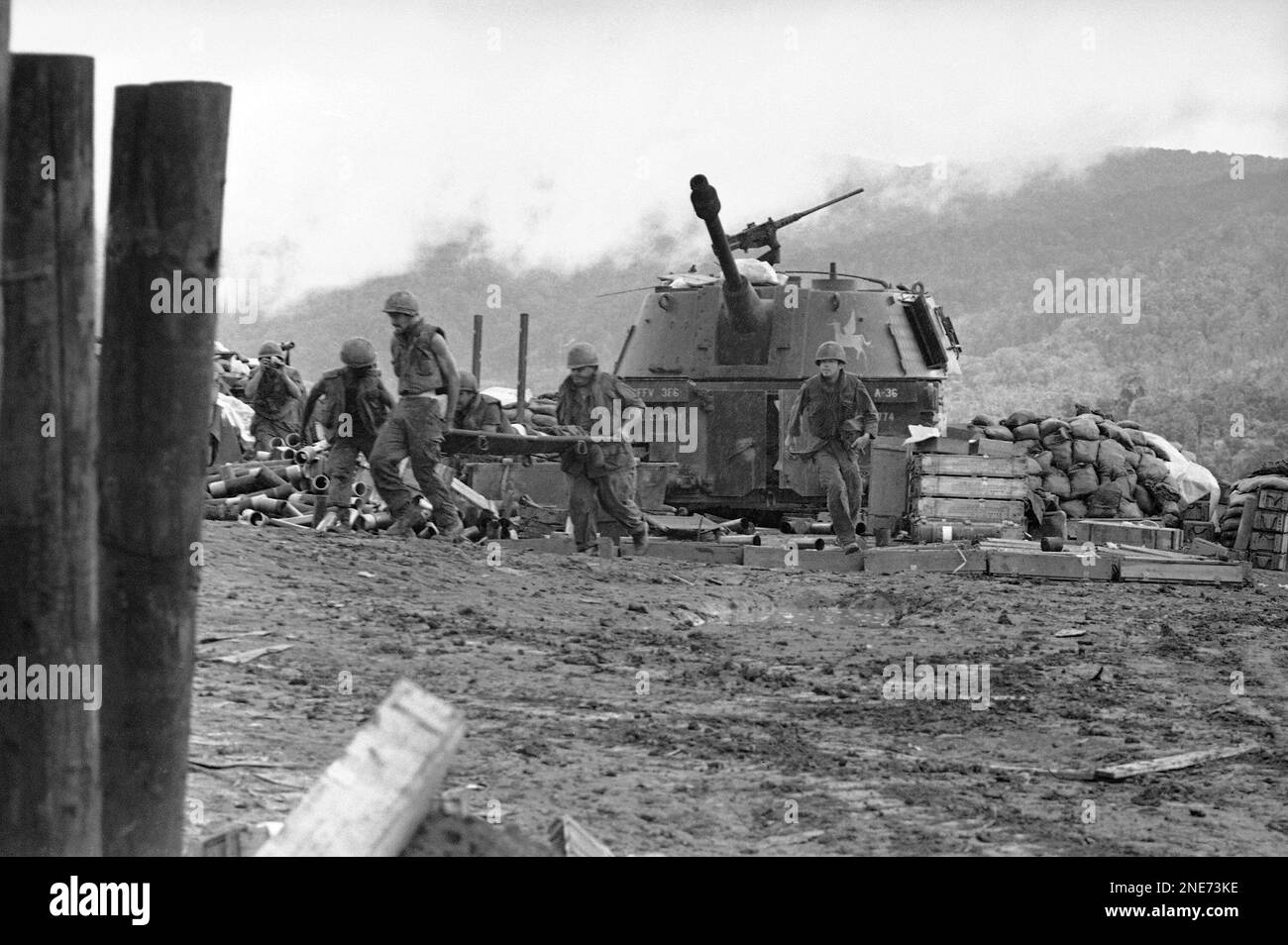 Medics and artillery men of a U.S. battery at Ben Het rush stretcher ...