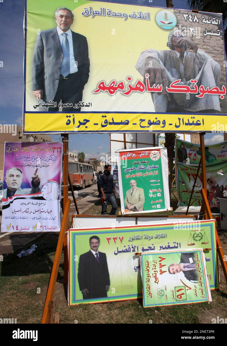 Election campaign posters for many candidates cover a street corner in ...