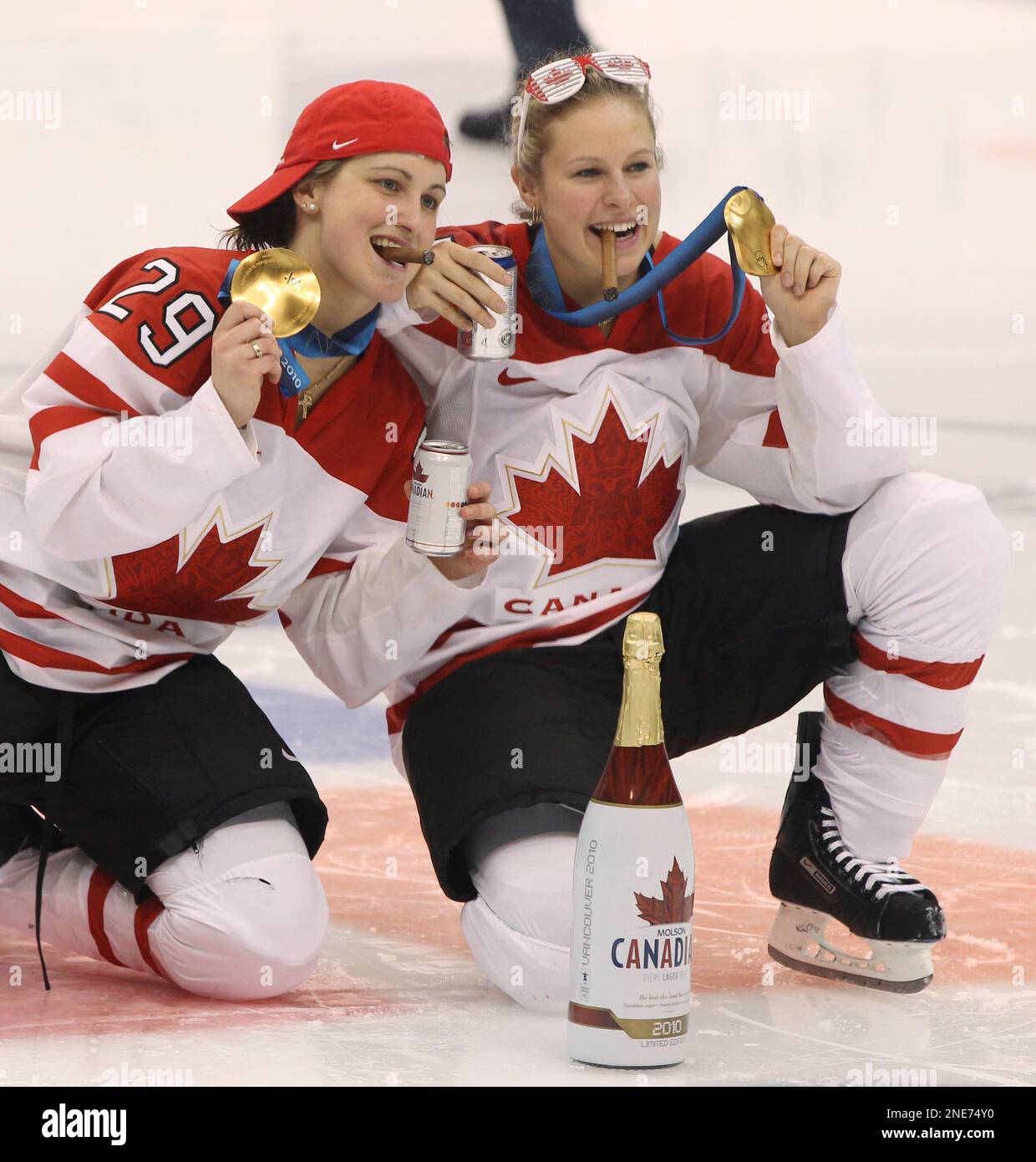 Canada's Marie-Phillip Poulin, left, and teammate Tessa Bonhomme smoke ...