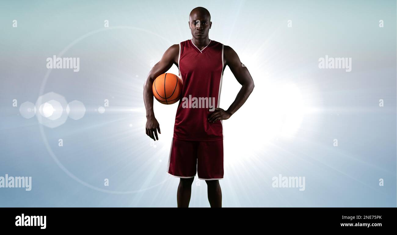 Composition of male basketball player holding basketball with copy ...