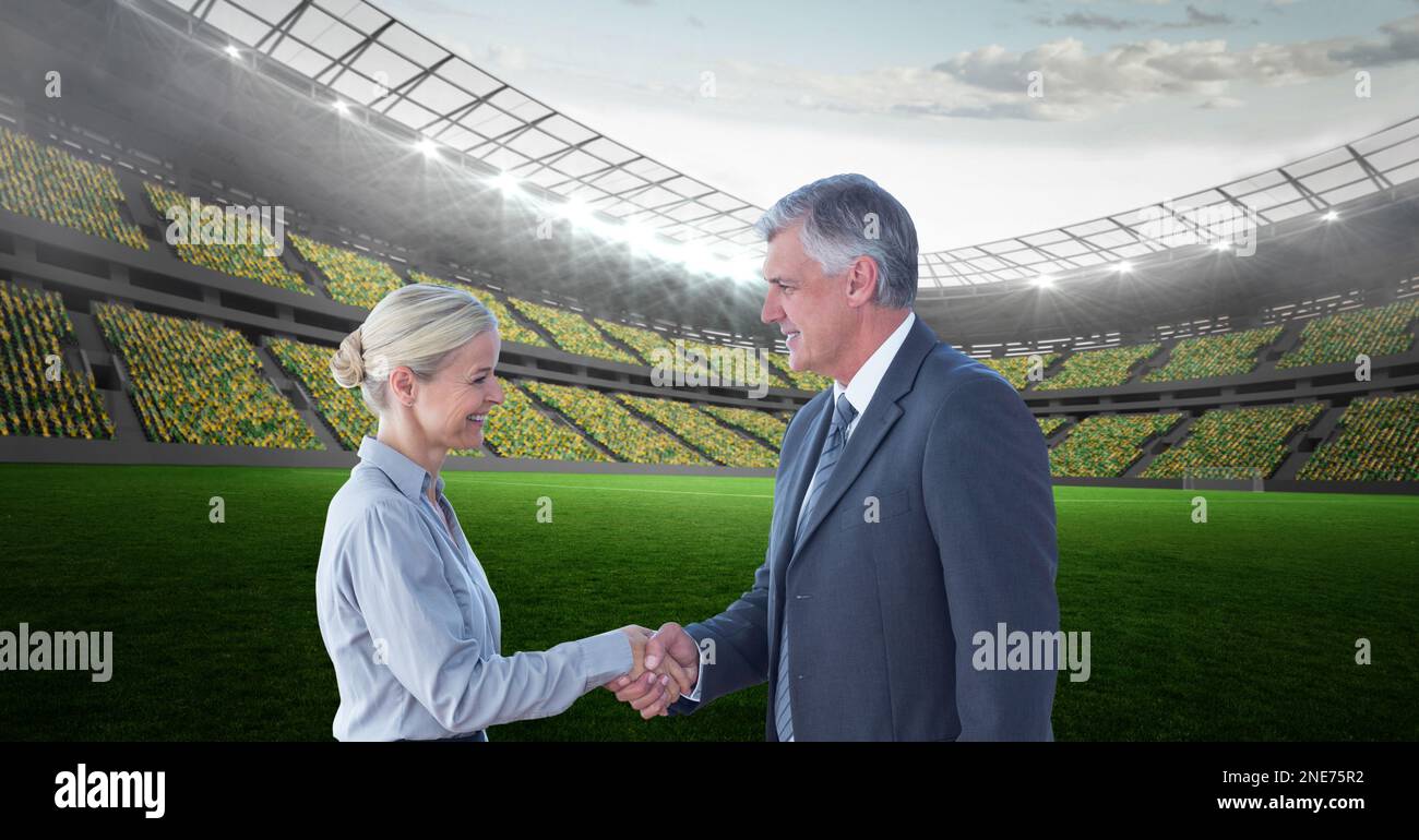 Composition of businessman and businesswoman shaking hands over sports ...