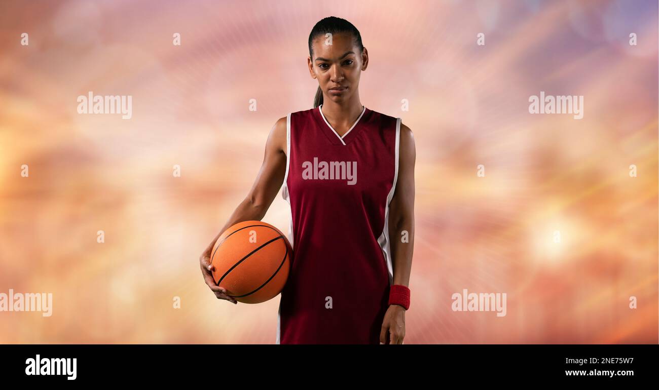 Composition of female basketball player holding basketball with copy ...