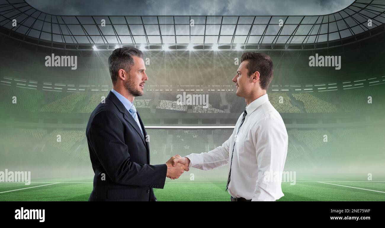 Composition of two businessmen shaking hands over sports stadium Stock ...