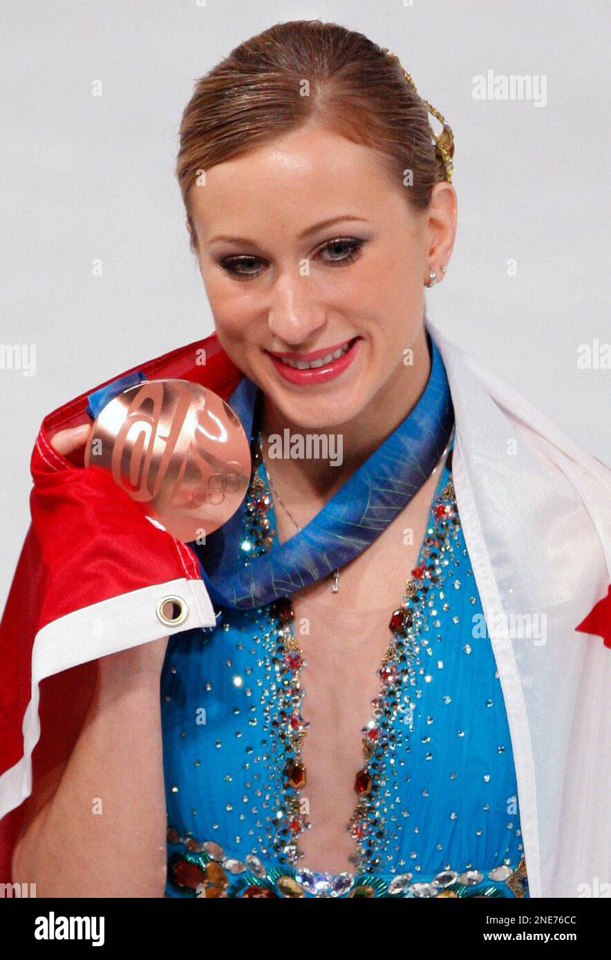 Joannie Rochette of Canada shows her bronze medal following her free ...