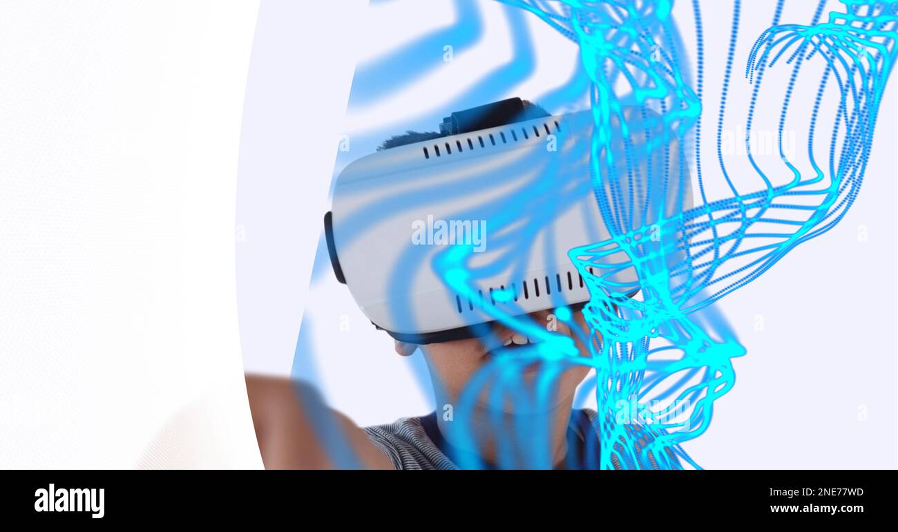 Composition of digital light trails with boy wearing vr headset Stock ...