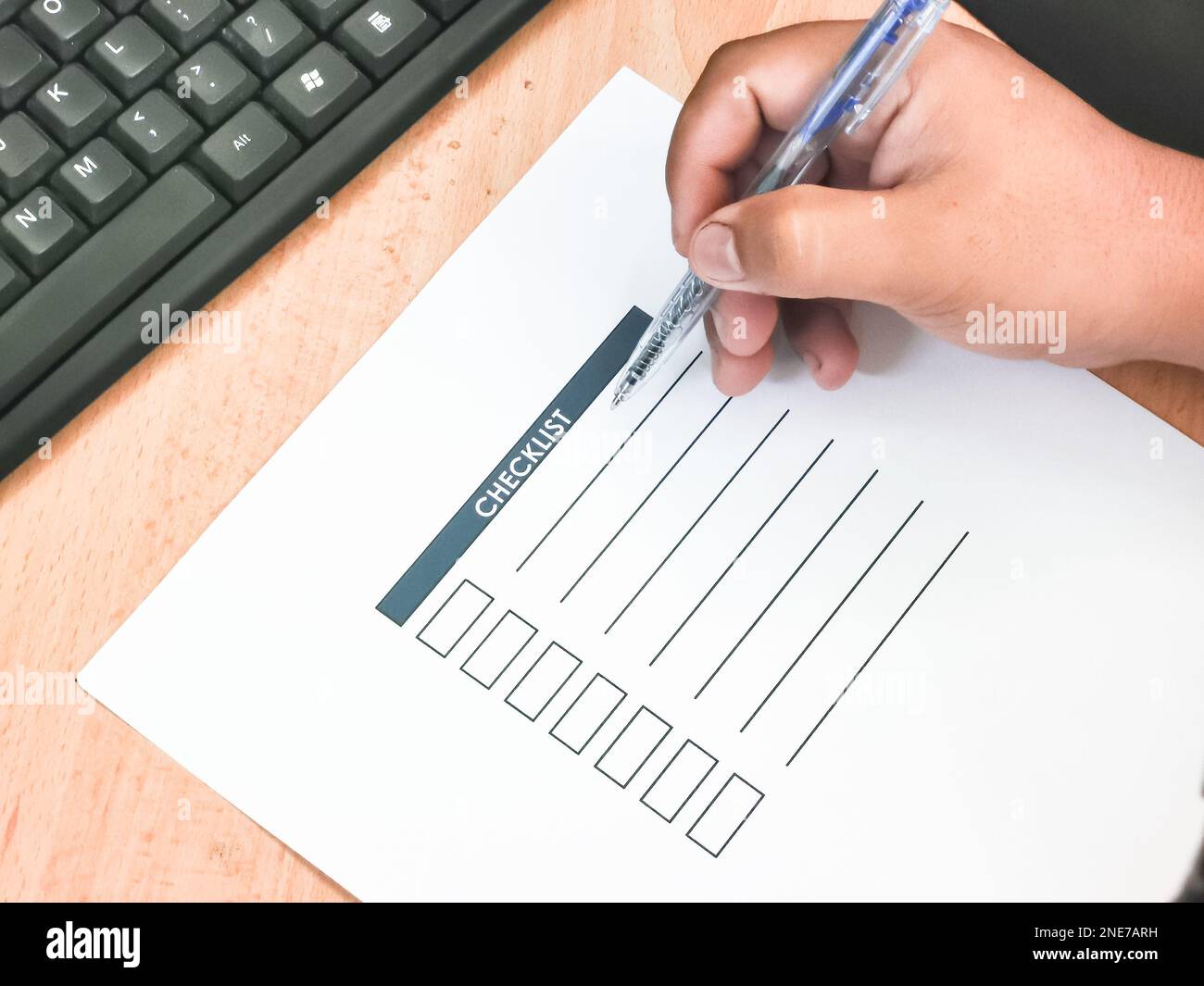 Checklist concept. Paper with checkbox and a hand holding a pen Stock ...