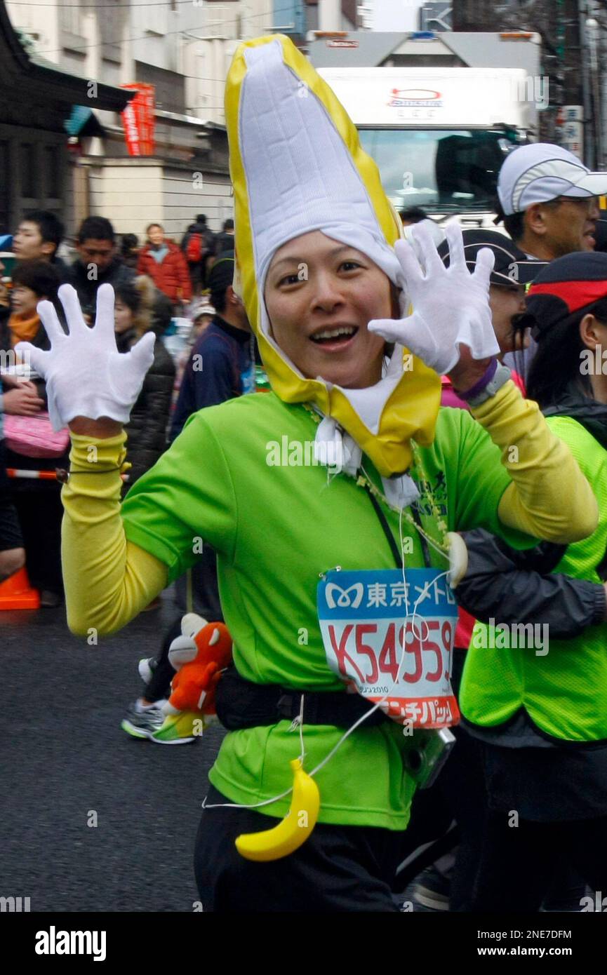 A participant dressed as a banana reacts as she runs at the Tokyo ...