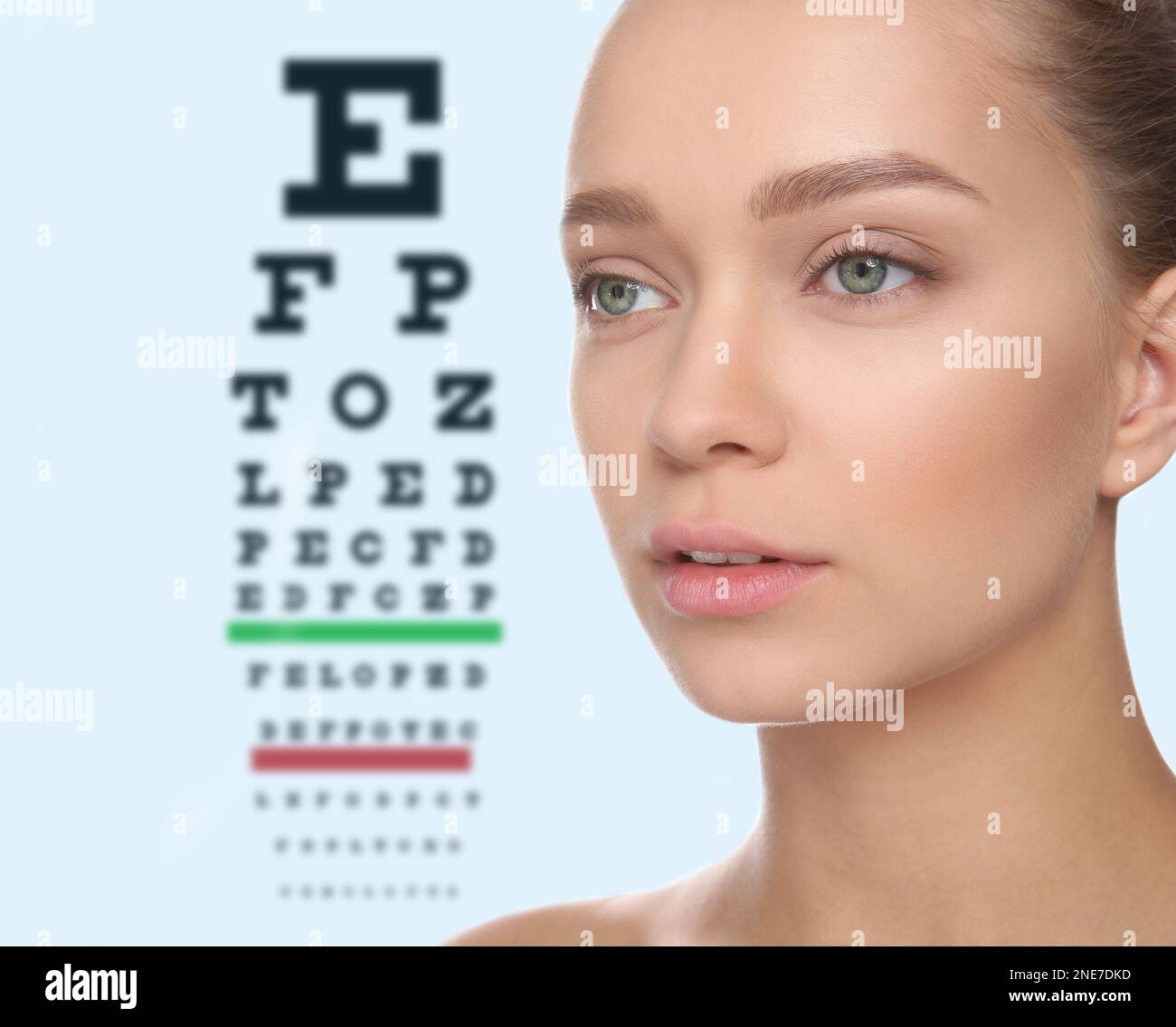 Young woman and blurred eye chart on background. Visiting ...