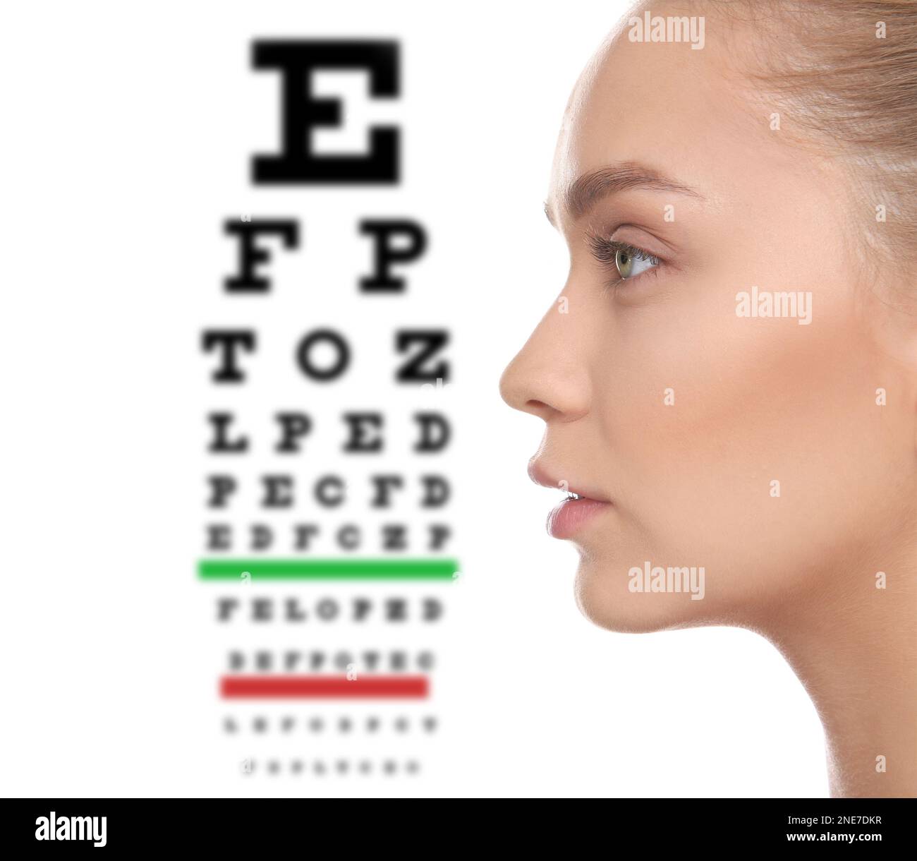 Young woman and blurred eye chart on background. Visiting ...