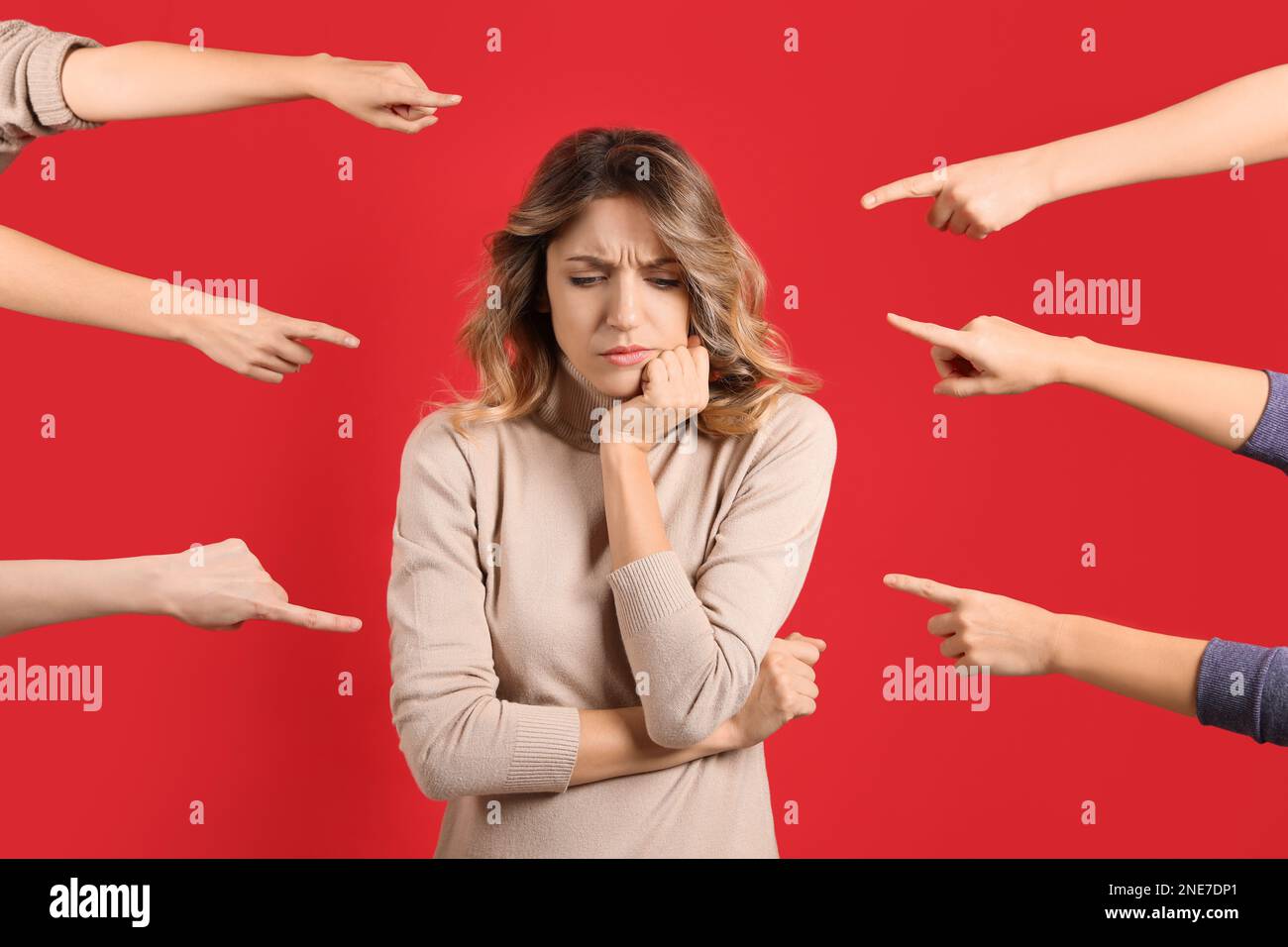 Stressed woman feeling uncomfortable because of people pointing at her ...