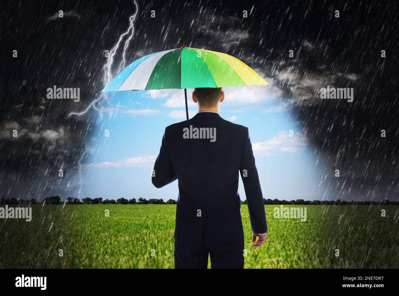 Businessman with umbrella under heavy rain. Insurance concept Stock ...