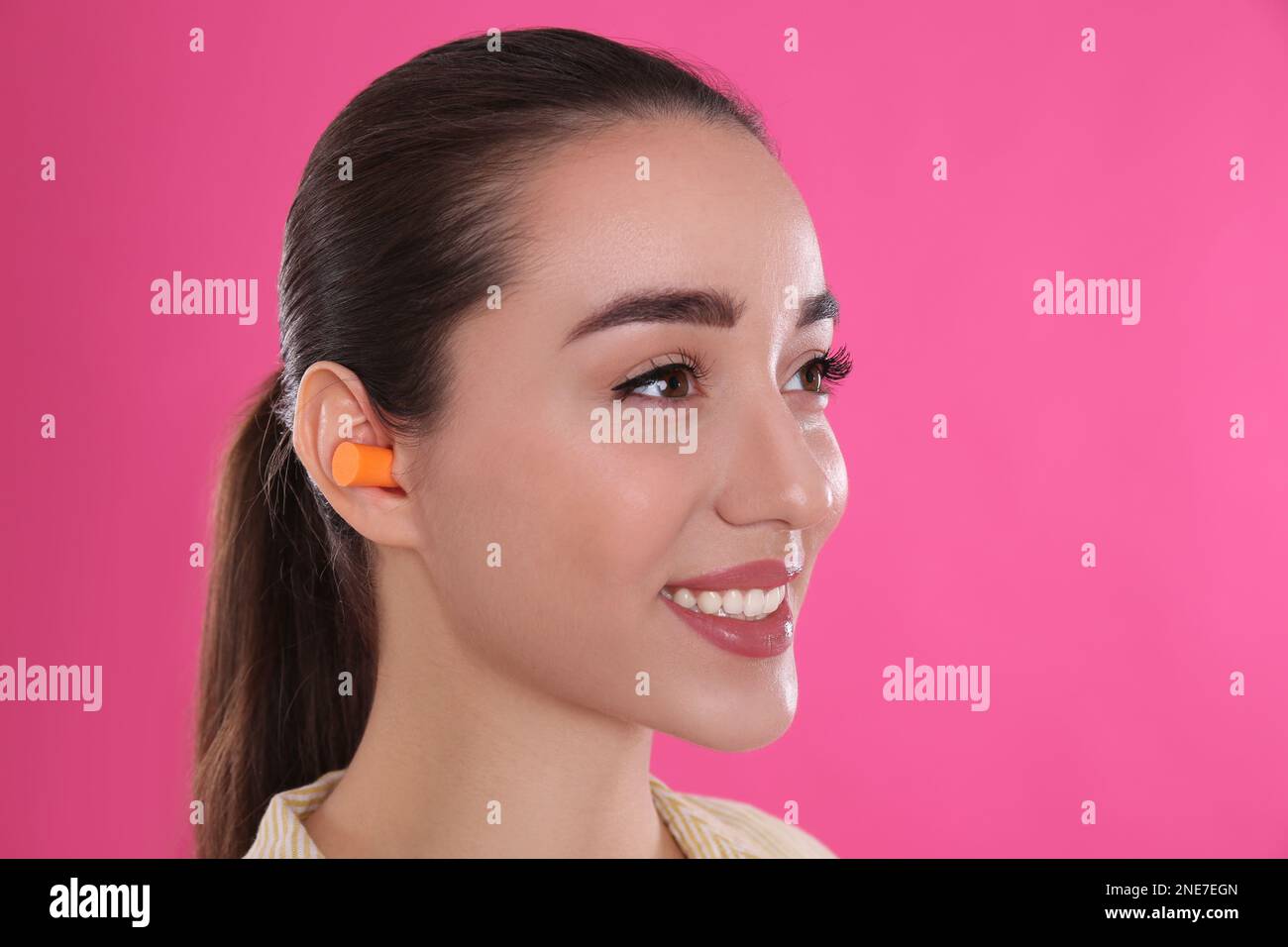 Woman wearing ear plugs hi-res stock photography and images - Alamy