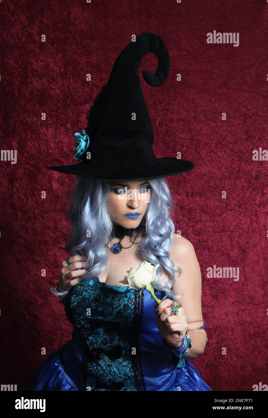 Woman Dressed as Blue Witch on Red Velvet Background Stock Photo - Alamy