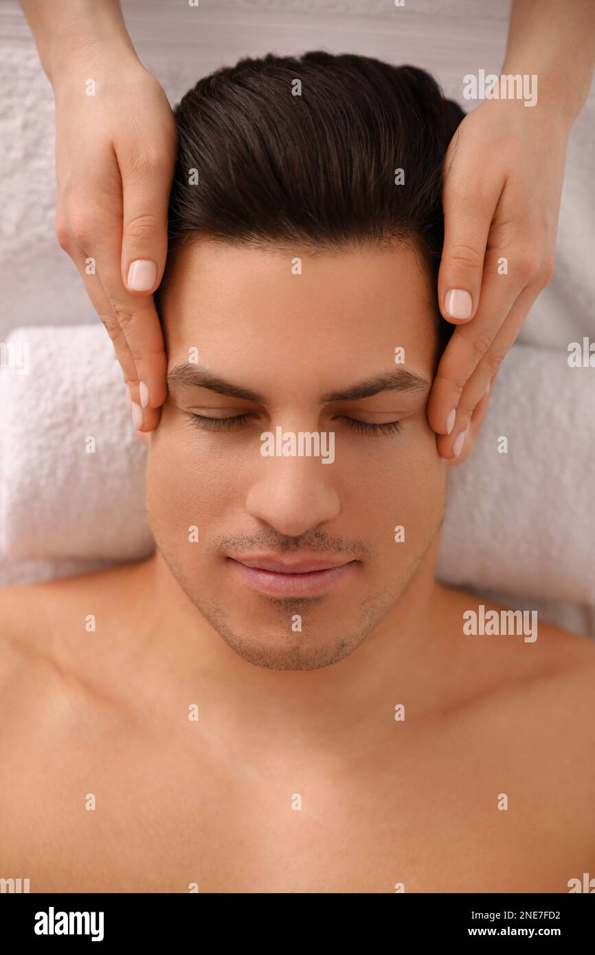 Handsome man receiving spa facial hi-res stock photography and images ...