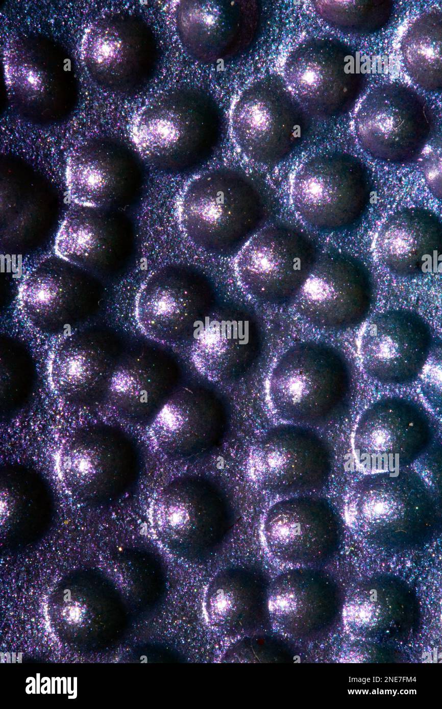 A Alien trypophobia holes in a shiny sci-fi close up background Stock ...