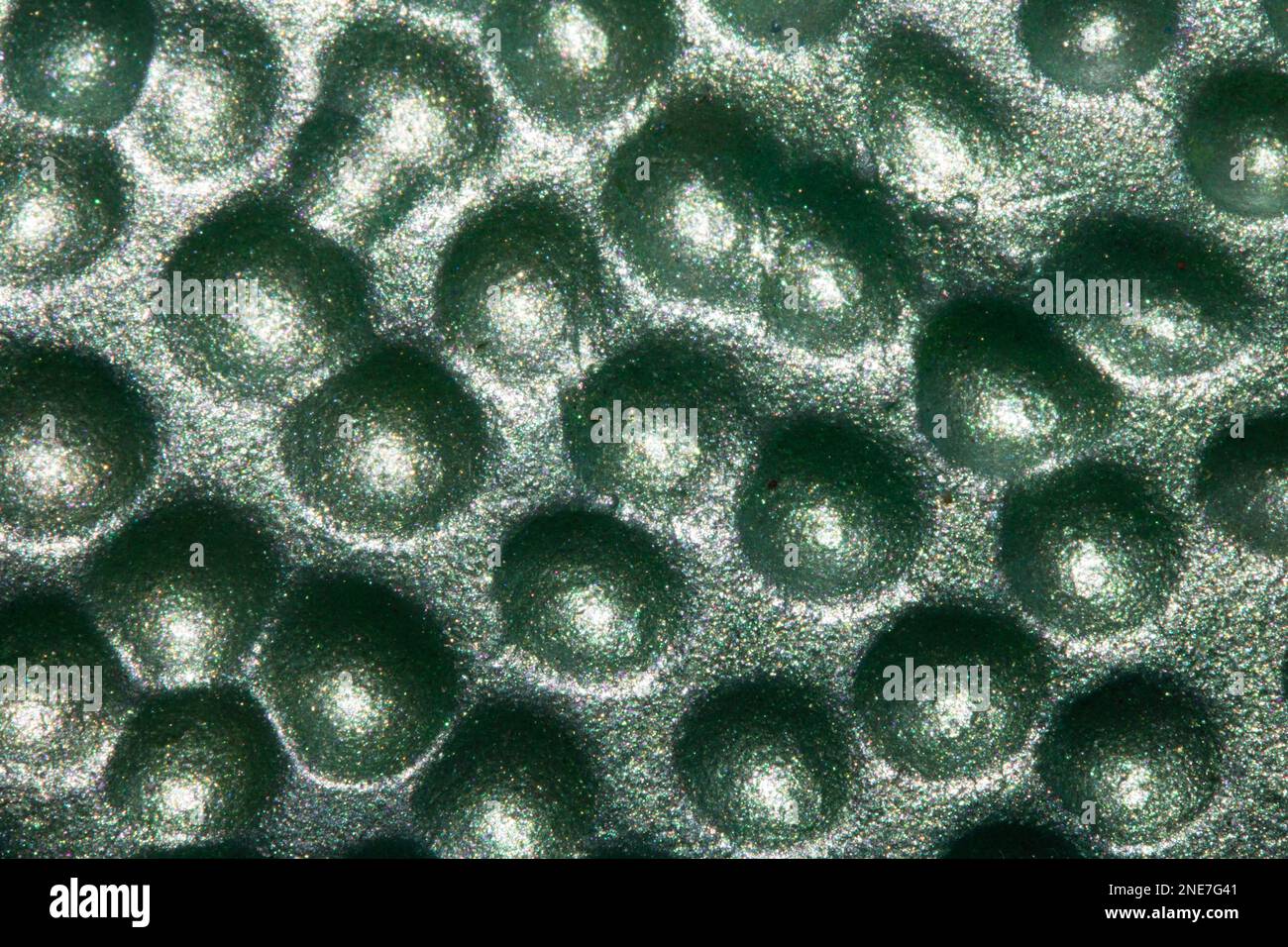 A Alien trypophobia holes in a shiny sci-fi close up background Stock ...
